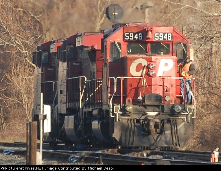 CP 5948 drifts back to iys train at CP JU